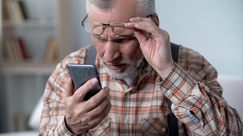 Bewildered Old Man Looking at Cellphone, New Technology Complicated for ... Bewildered Old Man Looking at Cellphone, New Technology Complicated for ...