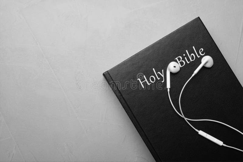 Bible and Earphones on Light Grey Background, Top View. Religious ...