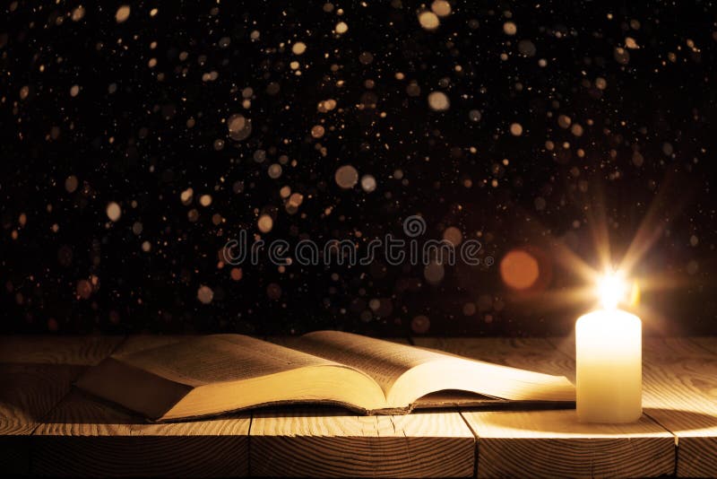 A Bible on the Table in the Light of a Candle Stock Photo - Image of ...