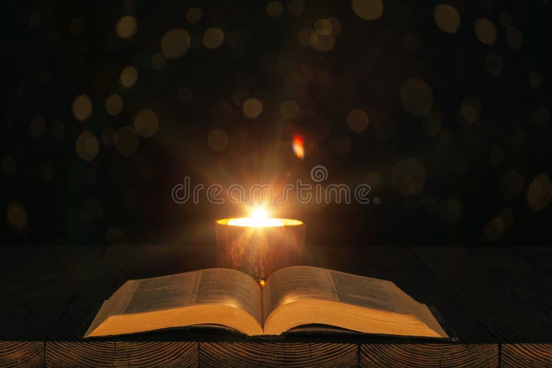 A Bible on the Table in the Light of a Candle Stock Photo - Image of ...