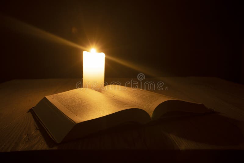 A Bible on the Table in the Light of a Candle Stock Photo - Image of ...