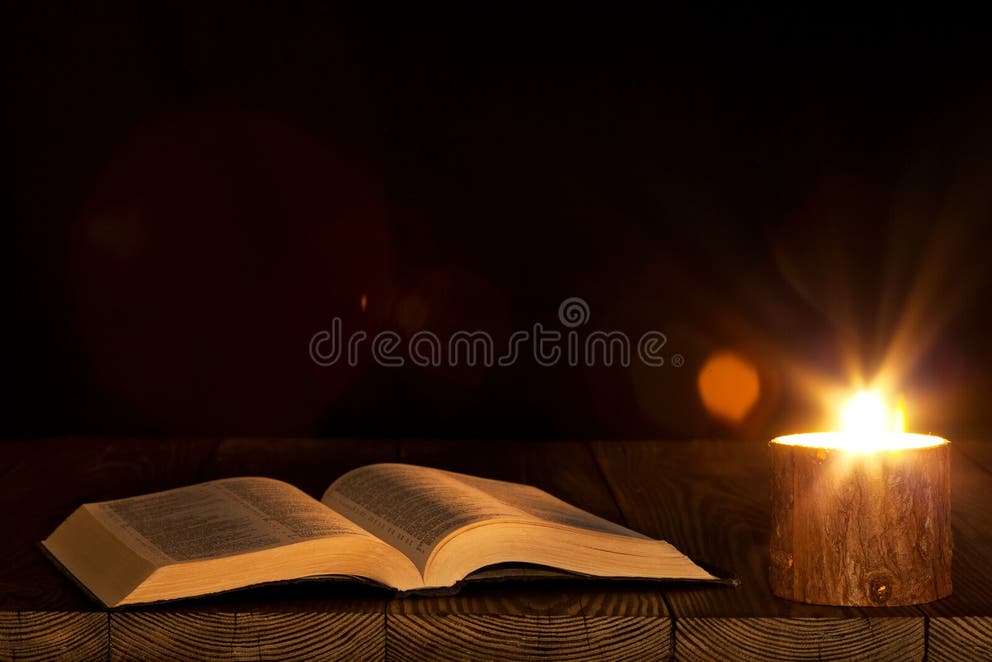A Bible on the Table in the Light of a Candle Stock Image - Image of ...