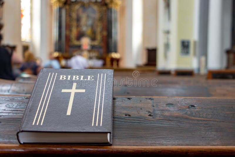 The Bible on the Table of a Prayer Bench in the Church with a Altar ...