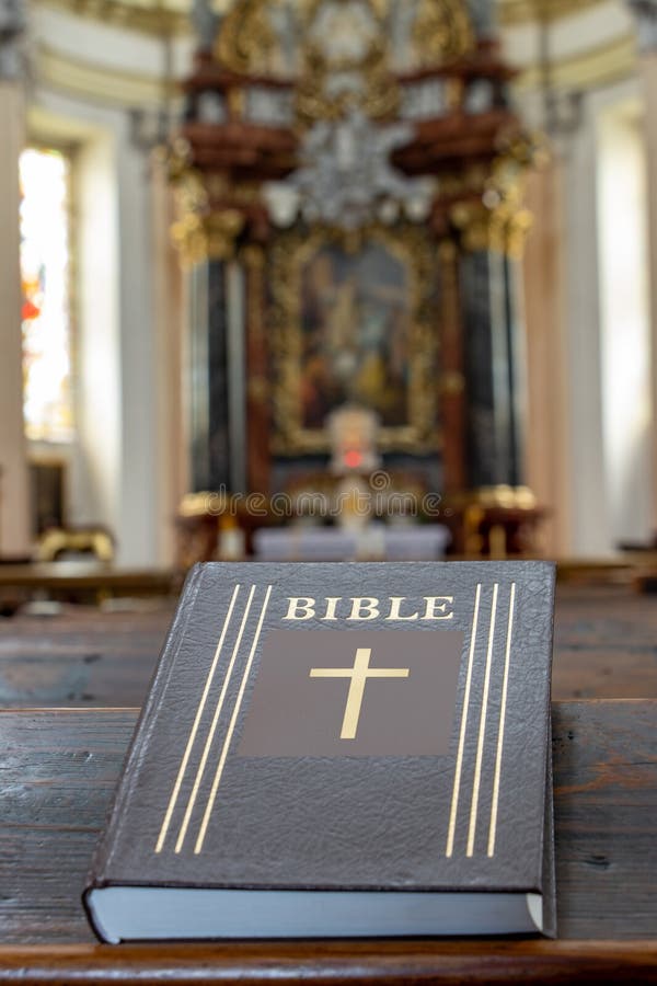 The Bible on the Table of a Prayer Bench in the Church with a Altar ...