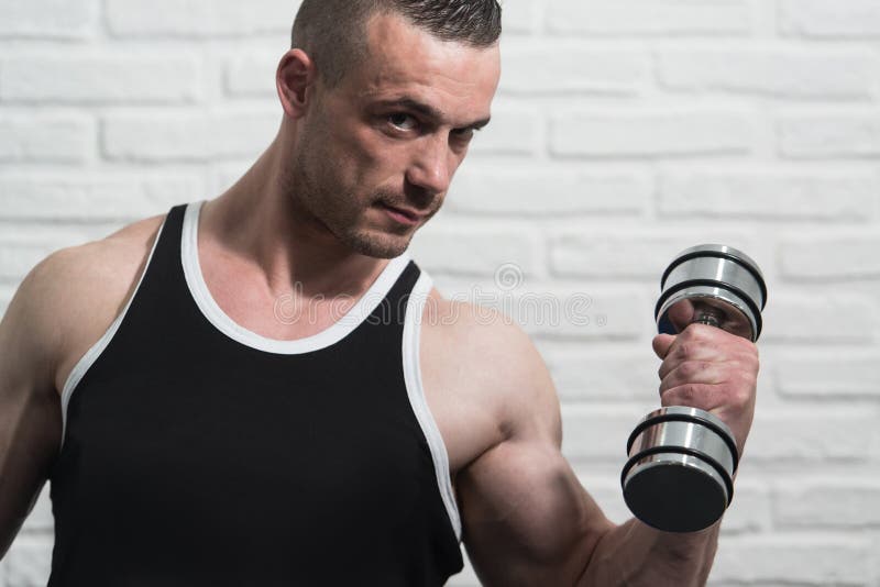 Biceps Exercise with Dumbbells on White Bricks Background Stock Photo ...