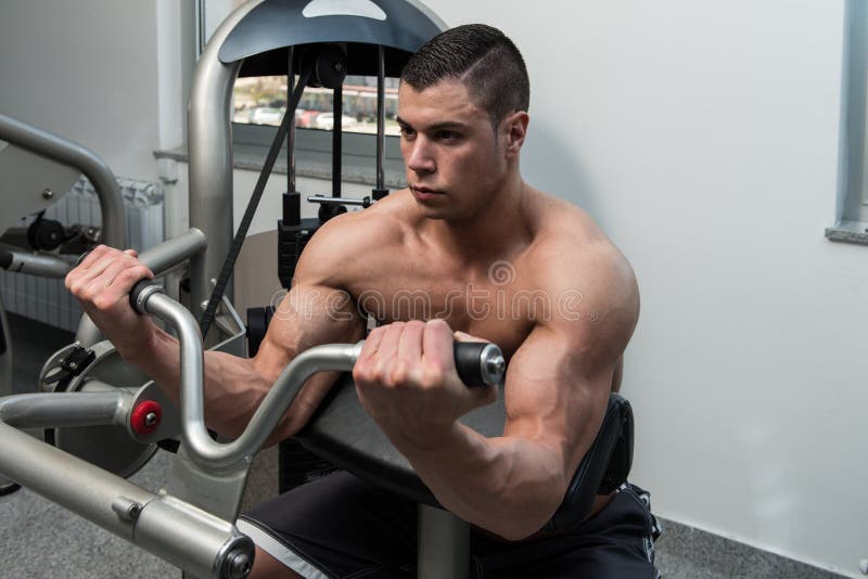 Biceps Workout on Machine stock image. Image of muscles - 62870785