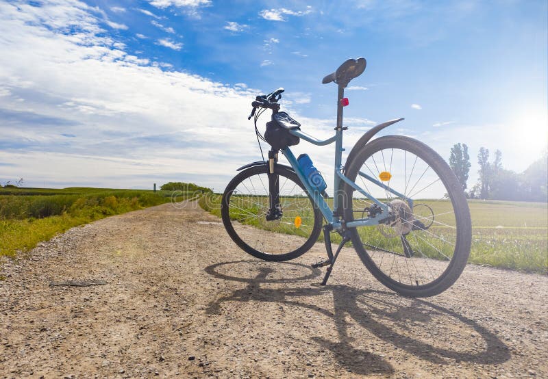 Bicycle on a country road stock photo. Image of green - 221602512