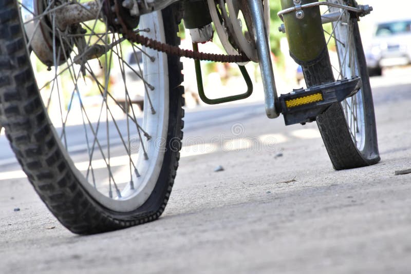 Bicycle with a Flat Rear Wheel in a City Park Close-up. Bicycle Wheel ...