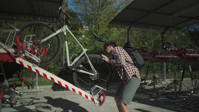 Bicycle Infrastructure. a Man Uses a Double Decker Bicycle Parking Lot ... Bicycle Infrastructure. a Man Uses a Double Decker Bicycle Parking Lot ...