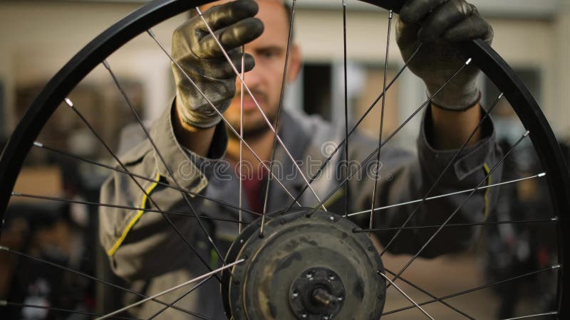 A Bicycle Master Repairs and Balances a Bicycle Wheel. Bicycle Service. Stock Footage - Video of ...
