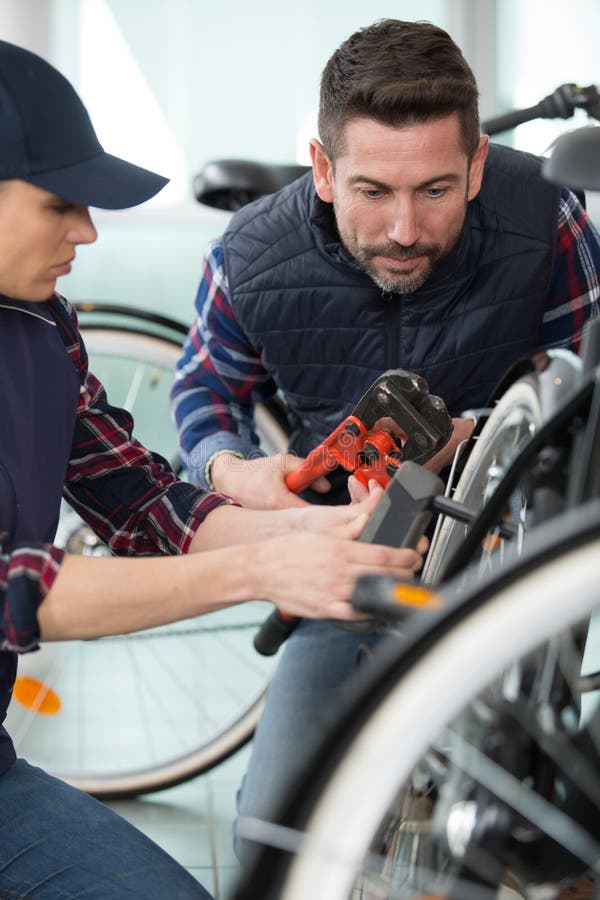 Bicycle Mechanic and Apprentice Repairing Bike in Workshop Stock Photo ...