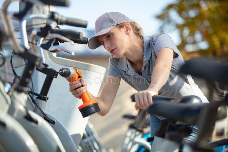 Bicycle Mechanic Using Drill on Bike Outdoors Stock Image - Image of ...
