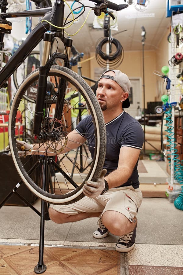 Bicycle Mechanic in a Workshop in the Repair Process Stock Photo ...