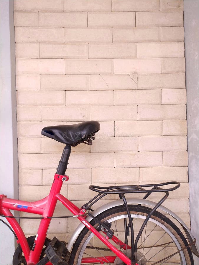 Bicycle Parked Next To a Wall with a Lock on it Stock Image - Image of ...