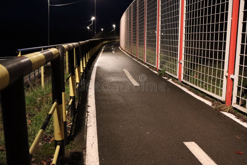 Bicycle Path with Fence on Both Sides Stock Photo - Image of city ...