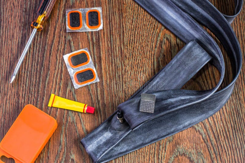 Bicycle Repair Kit, Wheels Camera on a Wooden Background Stock Photo ...