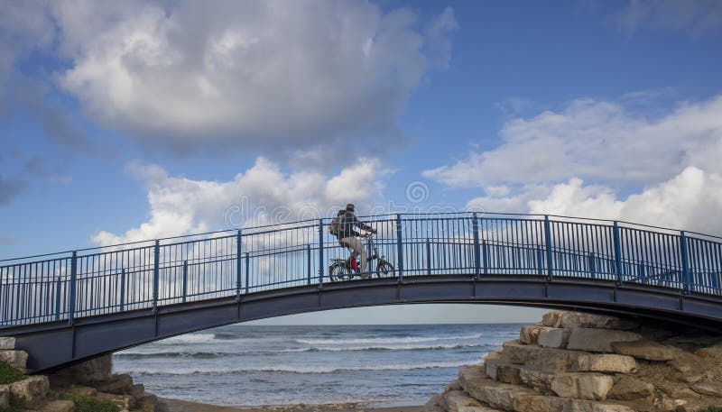 Bicycle Rider on a Bridge stock photo. Image of outdoors - 112704728