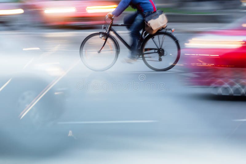 Bicycle Rider in City Traffic at Evening Stock Photo - Image of ride ...