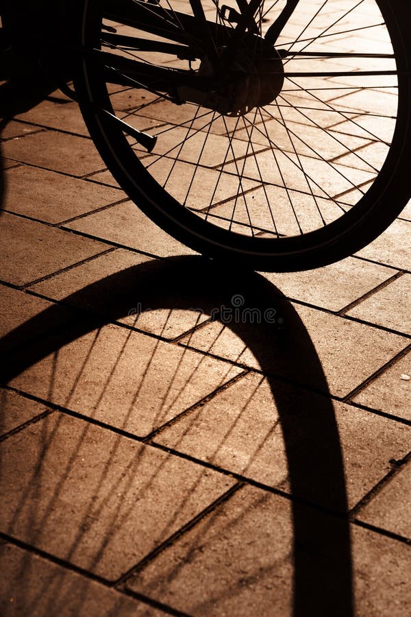 Bicycle Shadow on the Brick Ground with Sunlight Rays. Stock Image ...