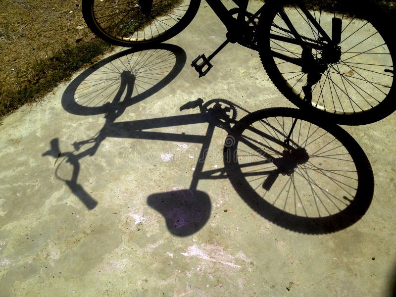 Bicycle shadow on ground stock image. Image of summer - 92474105