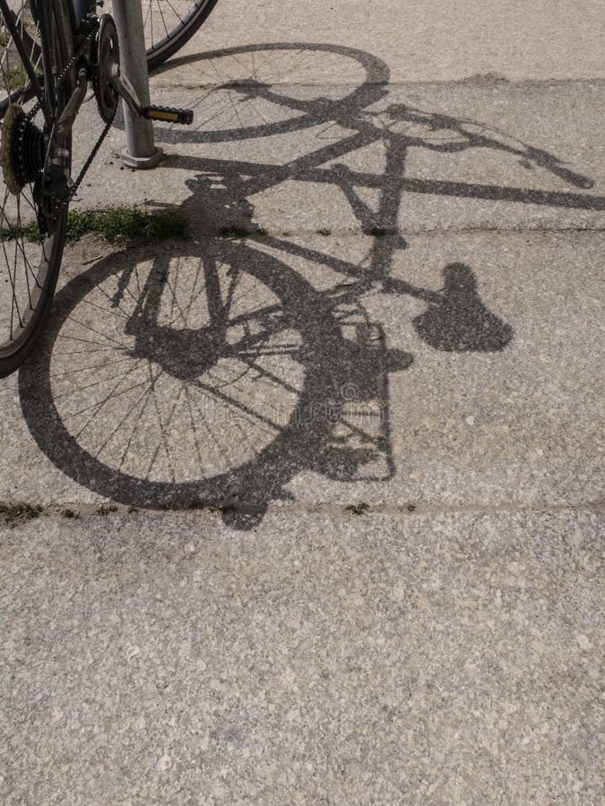 Bicycle shadow stock image. Image of city, pavementn - 93299747
