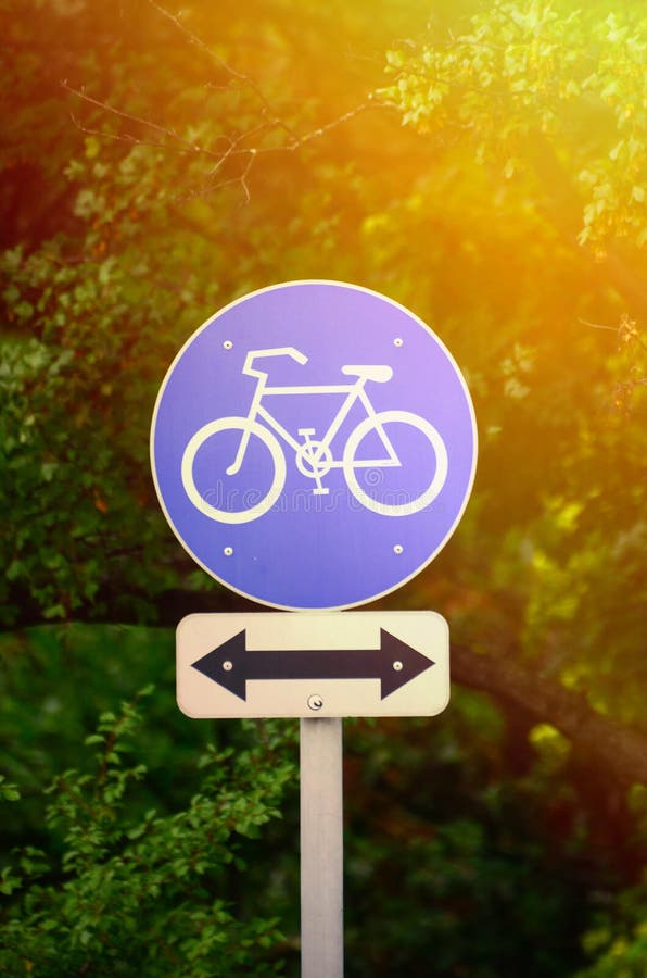 Bicycle Sign in Park with Arrow in Both Directions Stock Image - Image ...