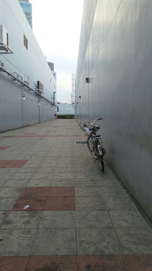 Bicycle stop in small lane stock photo. Image of lane - 57234502