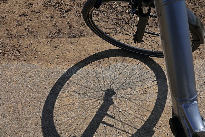 Bicycle Wheel and Its Shadow on the Asphalt Stock Photo - Image of ...
