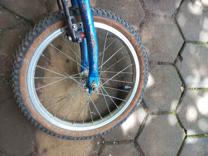 A Bicycle Wheel Lying on the Ground Editorial Photo - Image of tire ...