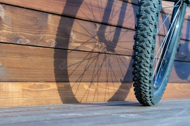 Bicycle Wheel with Shadow from Wheel on Wooden Boards Stock Photo ...