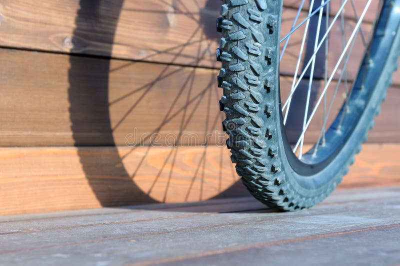 Bicycle Wheel with Shadow from Wheel on Wooden Boards Stock Image ...