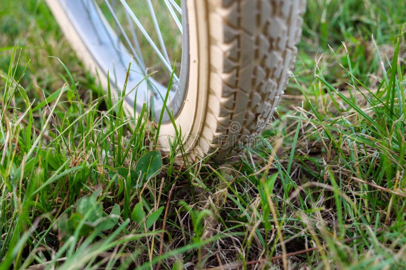 Bicycle Wheel with White Color Tire on the Grass Stock Photo - Image of ...