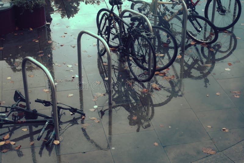Bicycles Secured in the Rain Editorial Photography - Image of damaged ...