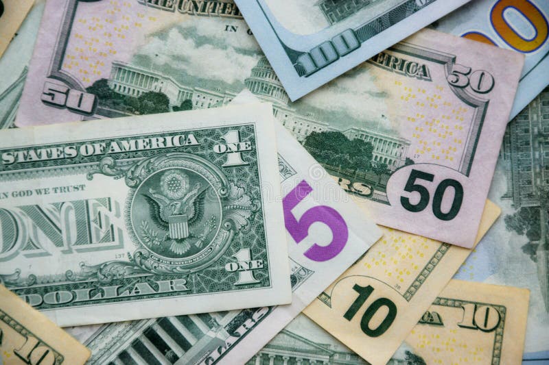 Big Amount of US Dollar Bills in Different Nominations on Table. Many ...