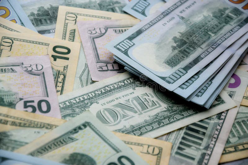 Big Amount of US Dollar Bills in Different Nominations on Table. Many ...