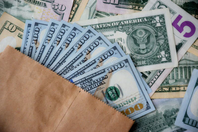 Big Amount of US Dollar Bills in Different Nominations on Table. Many ...