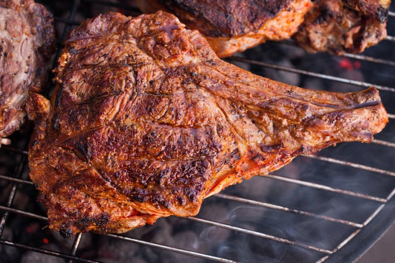 Big Beef Steak with Bone on Grilling Grid Over Barbecue Charcoal Stock ...