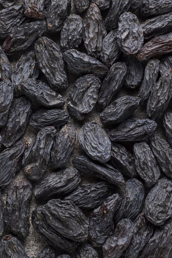 Big Black Raisins on the Table. Stock Photo - Image of tasty, vertical ...