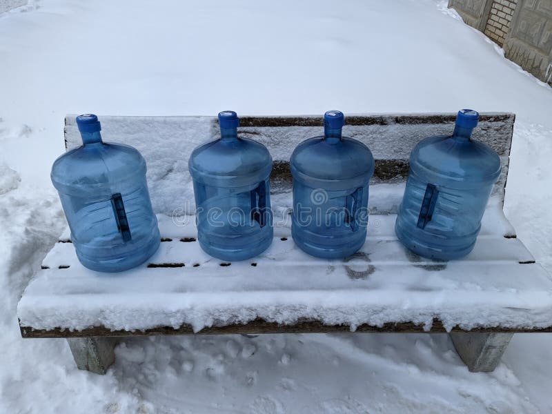 Big Blue and Empty Water Bottles on Benches in Winter. Stock Photo ...