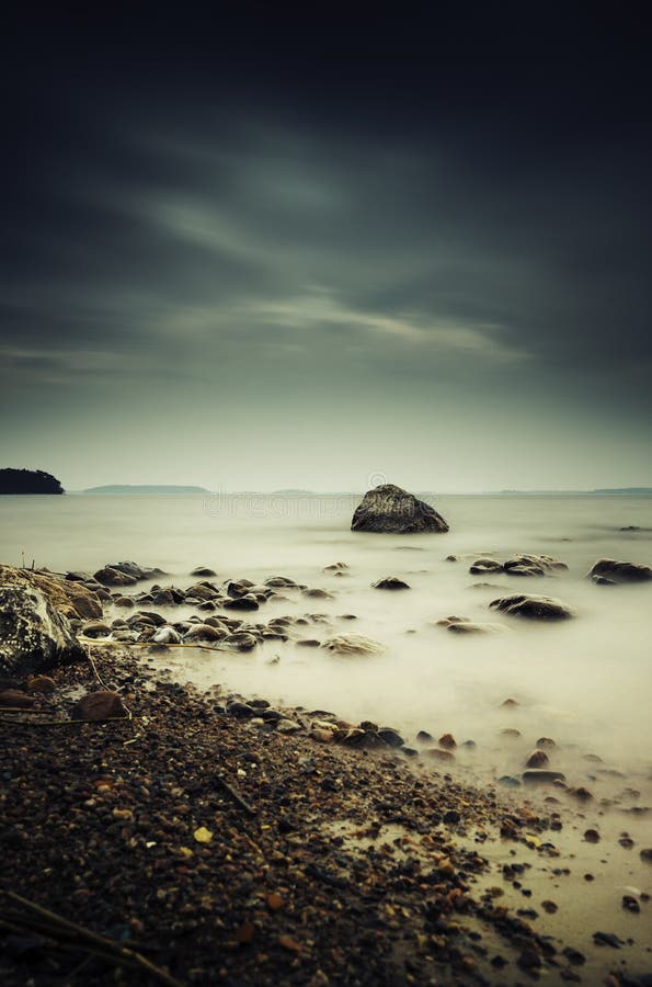 The big boulder in the sea stock image. Image of people - 41498401