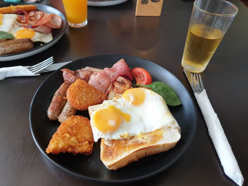 Big Breakfast with Fried Eggs, Sausages, Tomatoes and a Cup of Lemonade ...