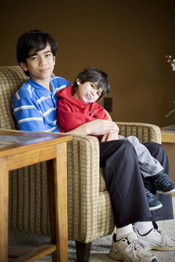 Big Brother Caring for Disabled Sibling Stock Image - Image of male ...