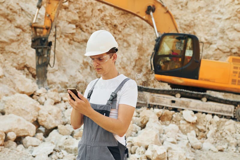 Big Career. Worker in Professional Uniform is on the Borrow Pit at ...