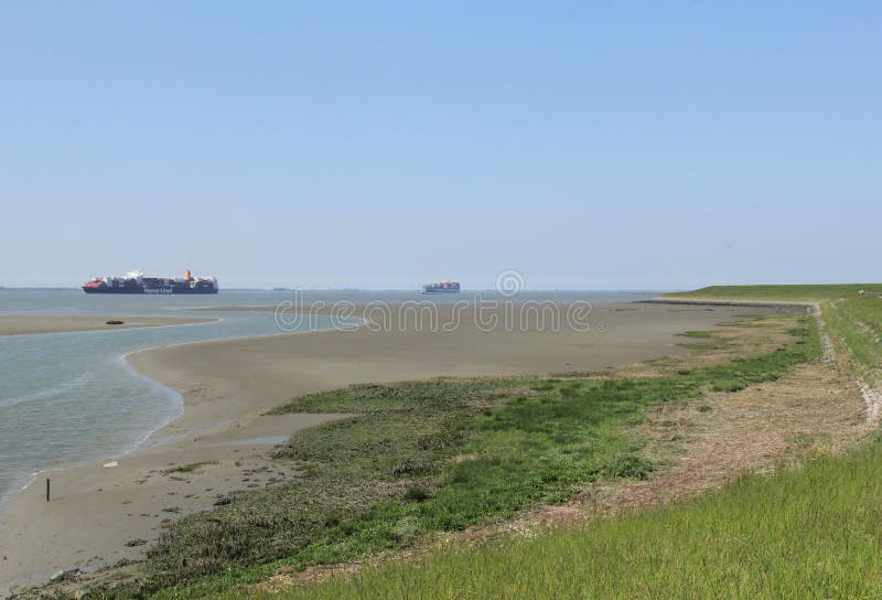 Big Cargo Ships are Navigating Along the Beach at the Dutch Coast ...