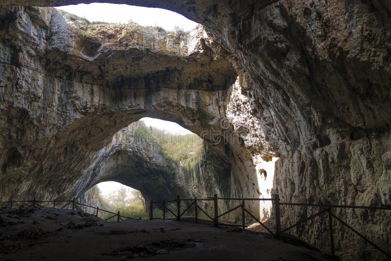 CAVE OPENINGS and CAVERNS in LARGE ROCK Stock Image - Image of ...