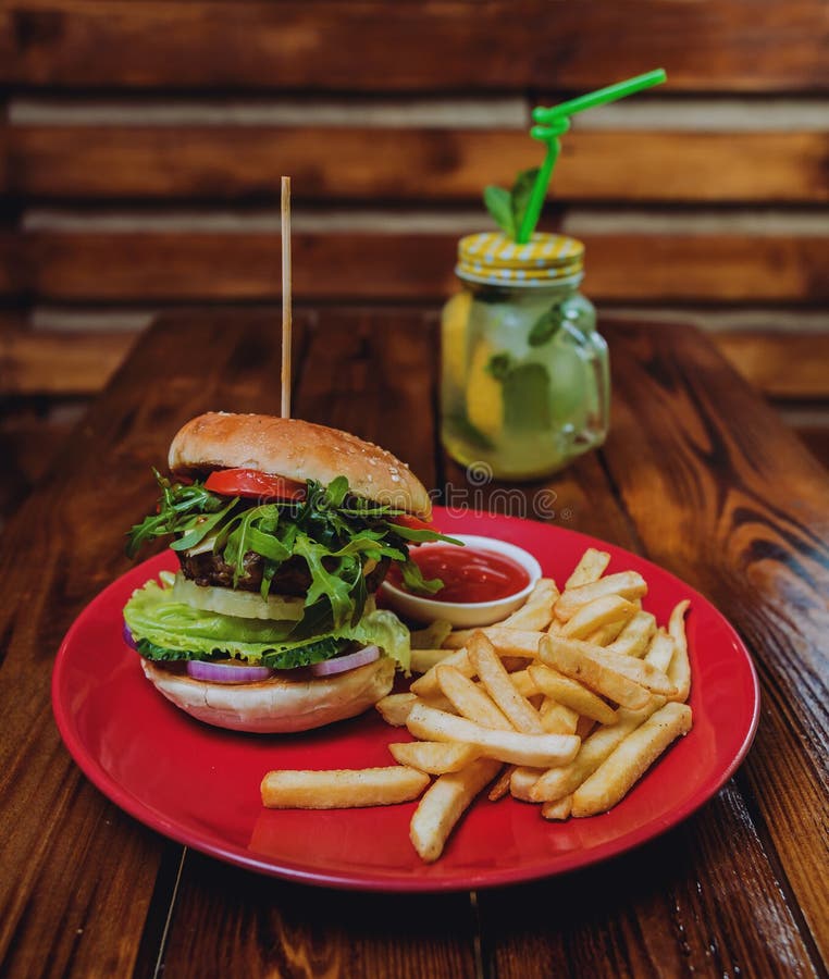Big Cheeseburger and Chips on a Plate. Stock Image - Image of ...