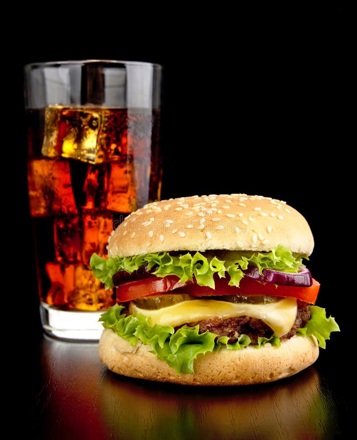 Big Cheeseburger with Glass of Cola on Black Wooden Table Stock Photo ...