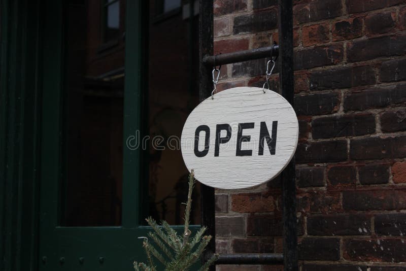 Big Circular Wooden Open Sign Hanging in Front of a Building Stock ...