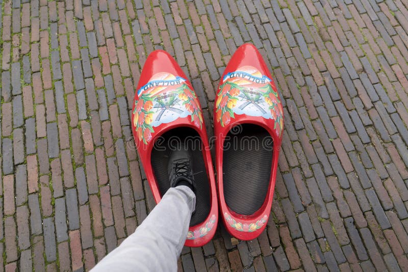 Big Clogs with Man`s Leg in Holland. Man Try Big Clogs in Nederland ...