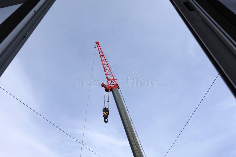 Big Heavy Hook with Yellow Stripes on Metal Cable on Construction Arm ...